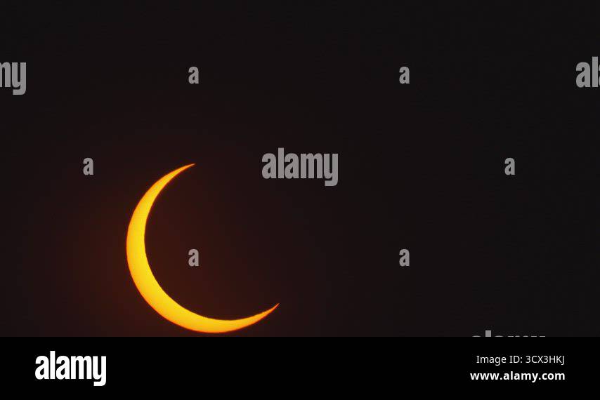 Close up of partial solar eclipse while sun is moving on the sky. Some ...
