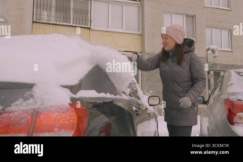. Woman clean car snow for concept design. Cleaning concept. Winter ...