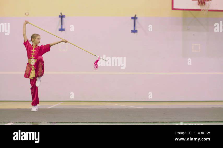 Young girl in red yifu clothes doing qiansho form exercises china kung ...