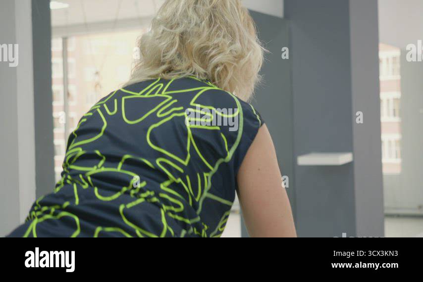 Sport woman training on static bike while cycling class in gym club ...