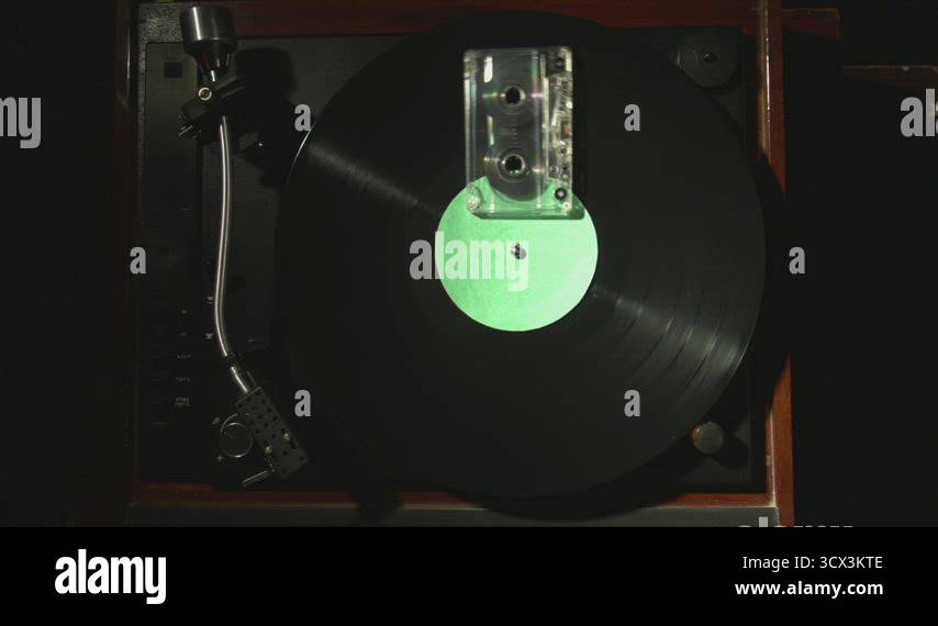 Vintage concept of audio tape cassette and vinyl green disc top view of ...