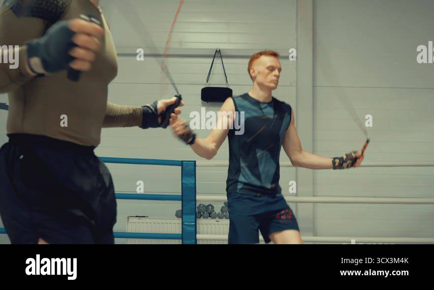 Two boxer training on skipping rope in fight club. Cardio training ...