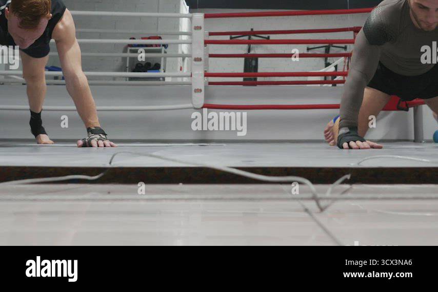 Boxer man training push ups exercises and clapping hands in gym ...