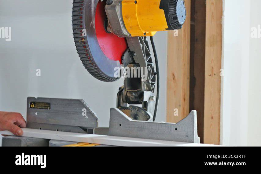 Working carpenter using circular saw rotating saw cutting wood ...