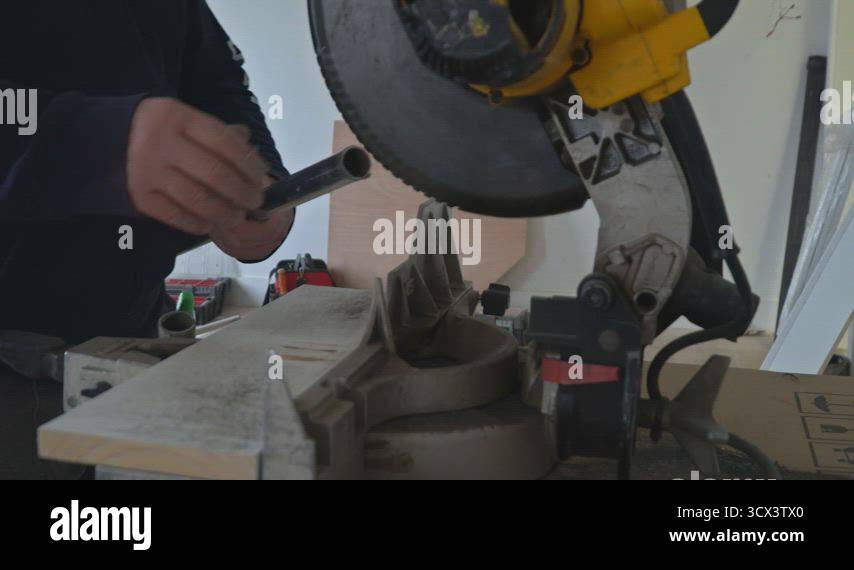Craftsman sawing metal with disk grinder in sparks while grinding iron ...