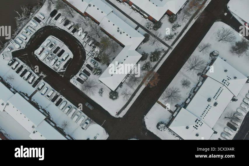 Flying over snow covered houses along frozen city street Stock Video ...