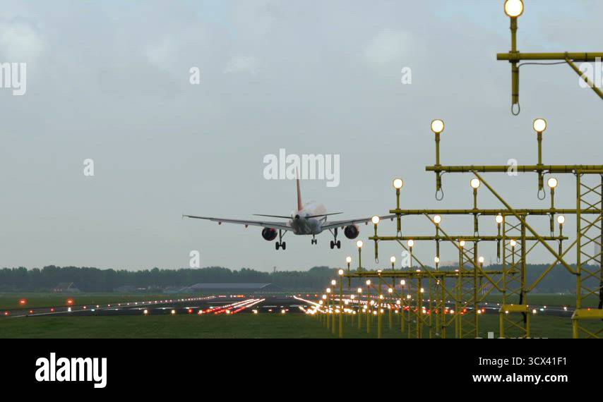 Airplane landing behind runway lights Stock Video Footage - Alamy