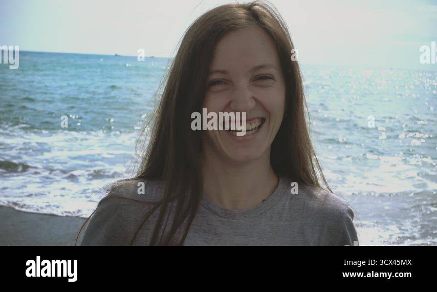 Girl laughing portrait by the sea Stock Video Footage - Alamy