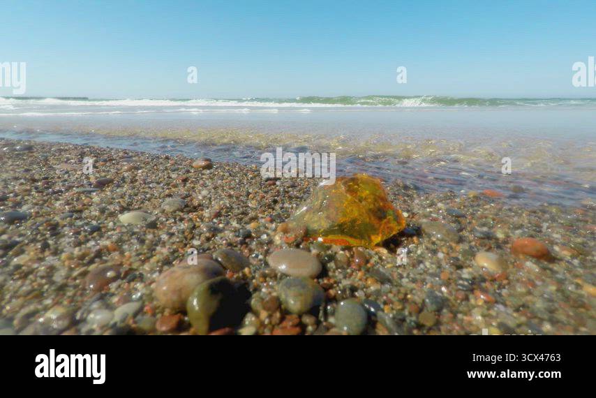 Amber in the surf of the Baltic Sea with blue sky Stock Video Footage ...