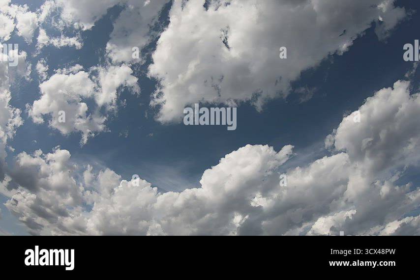 Time lapse of white clouds that change shape and disappear into a deep ...