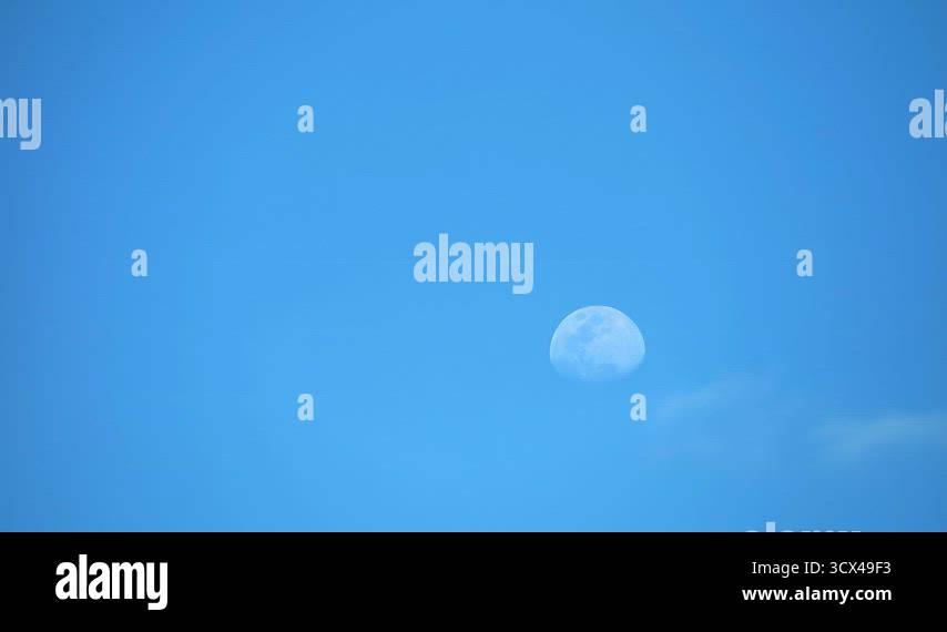 half moon move on clear blue sky time lapse Stock Video Footage - Alamy
