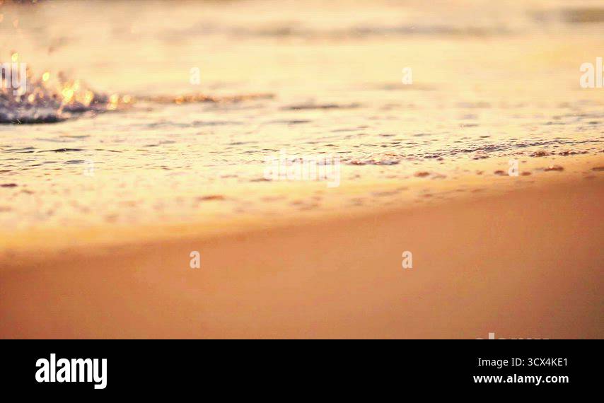beach wave splashing macro in sunset Stock Video Footage - Alamy