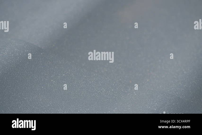 Twisting the roof self-tapping screw into the metal tile. Close up ...