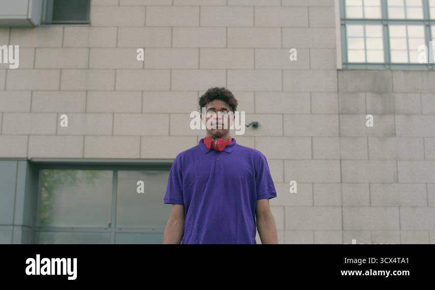 MS Man standing and throwing skateboard backwards, Milan, Italy Stock ...