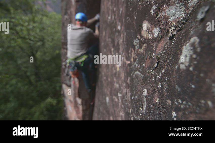 CU SELECTIVE FOCUS TU Man rock climbing along crevice, Liming, Yunnan ...