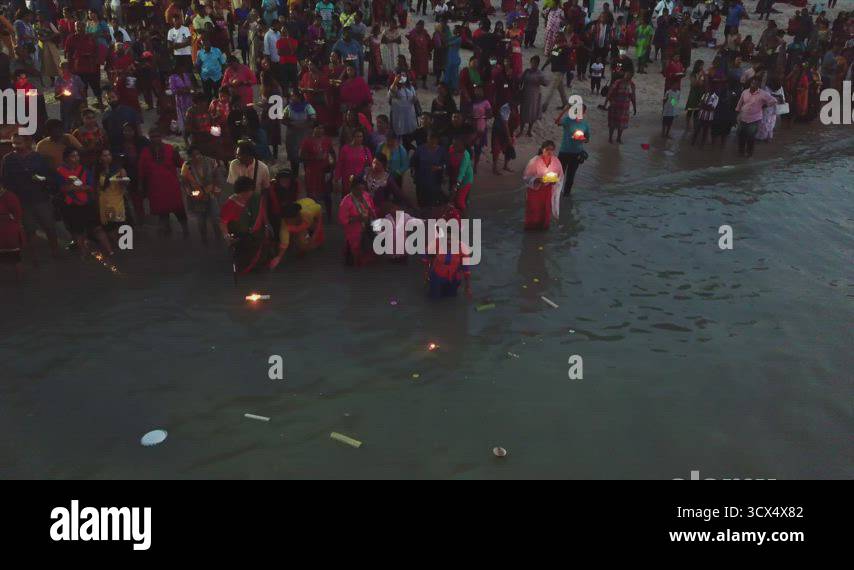 Hindu devotees release floating candle to sea during floating chariot ...