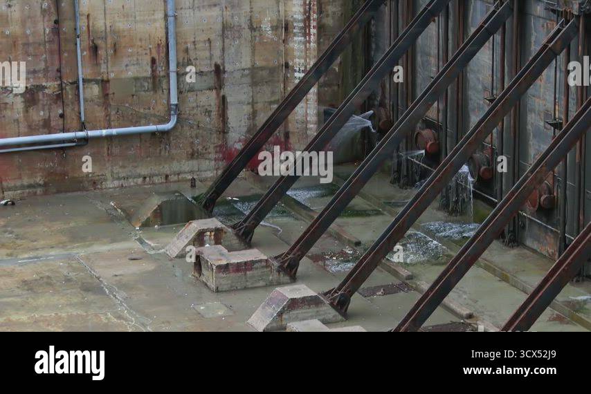 Water coming from metal walls to fill construction site for ship dry ...
