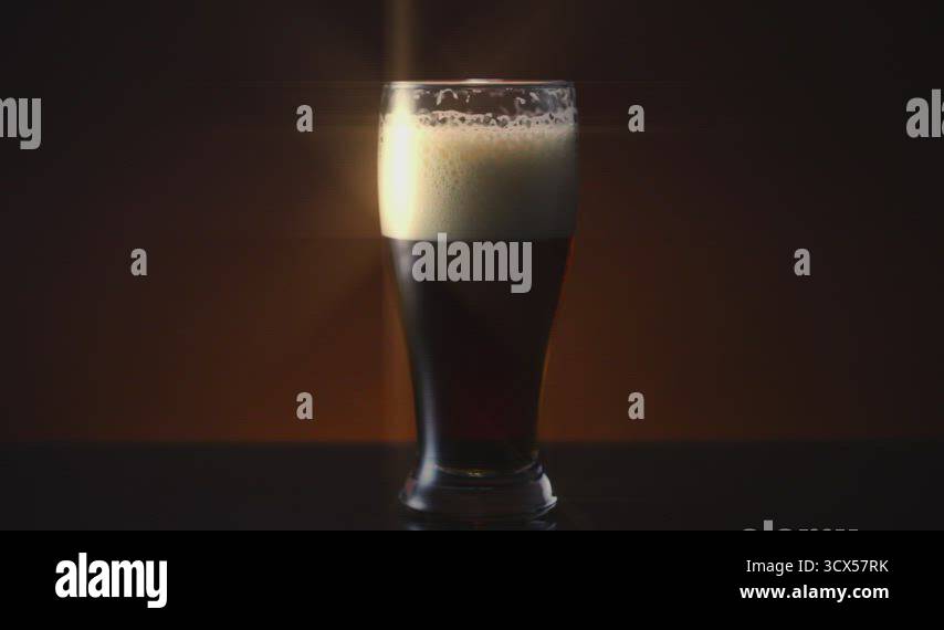 Dark Amber Beer in Pilsner Glass Star Filter Stock Video Footage - Alamy
