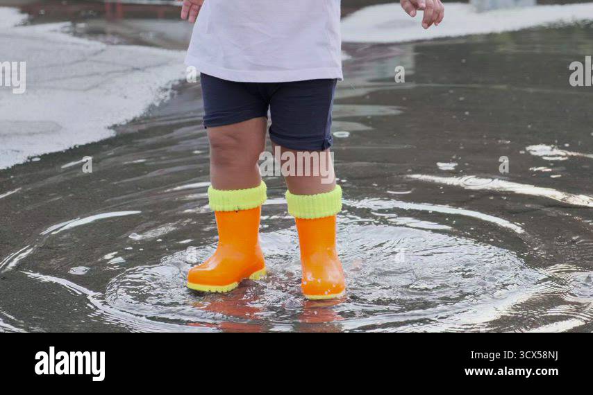 Child in rain puddle Stock Videos & Footage - HD and 4K Video Clips - Alamy