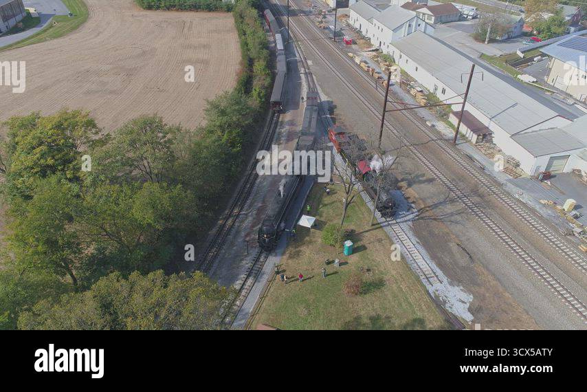 Aerial View of multiple antique restored steam engines in a train yard ...