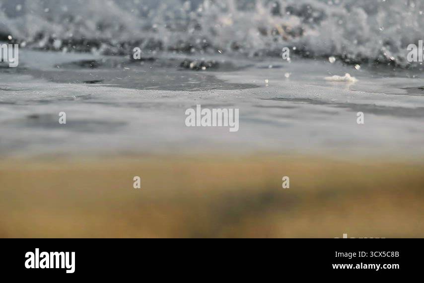 beach wave splashing macro in sunset Stock Video Footage - Alamy
