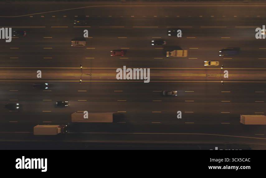 Cars on Illuminated Highway in City at Night. Aerial Vertical Top-Down ...