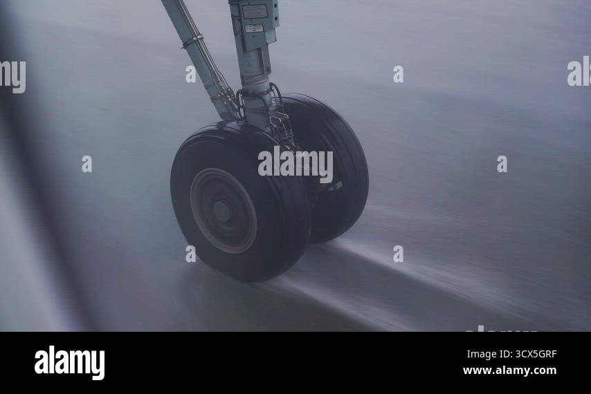 Airplane landing gear taxiing the runway in heavy rain Stock Video ...