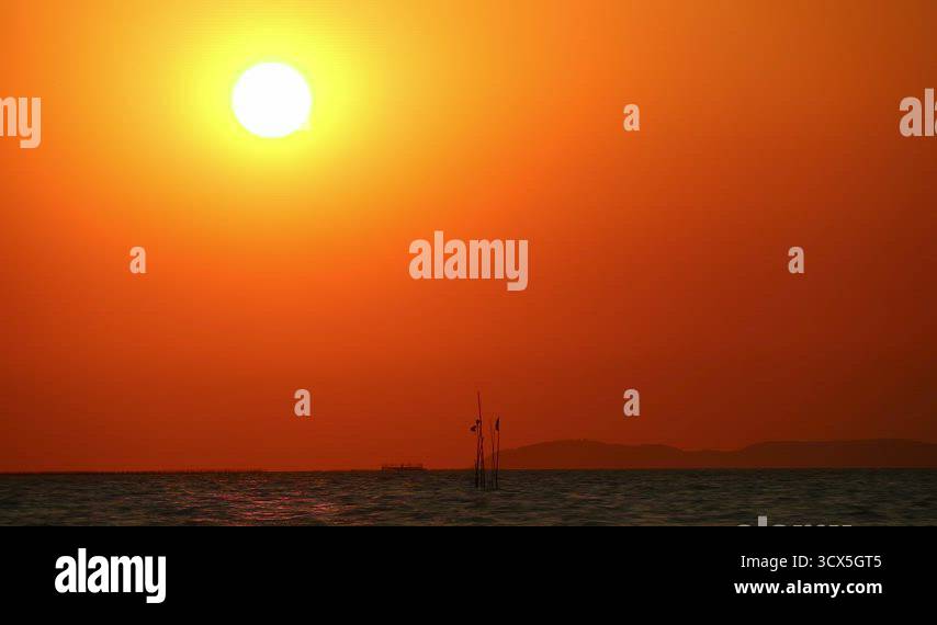 sunset orange sky fishing boat passing time lapse silhouette island ...