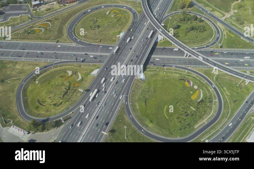 Complex Road Junction and Cars Traffic at Sunny Summer Day. Drone is ...