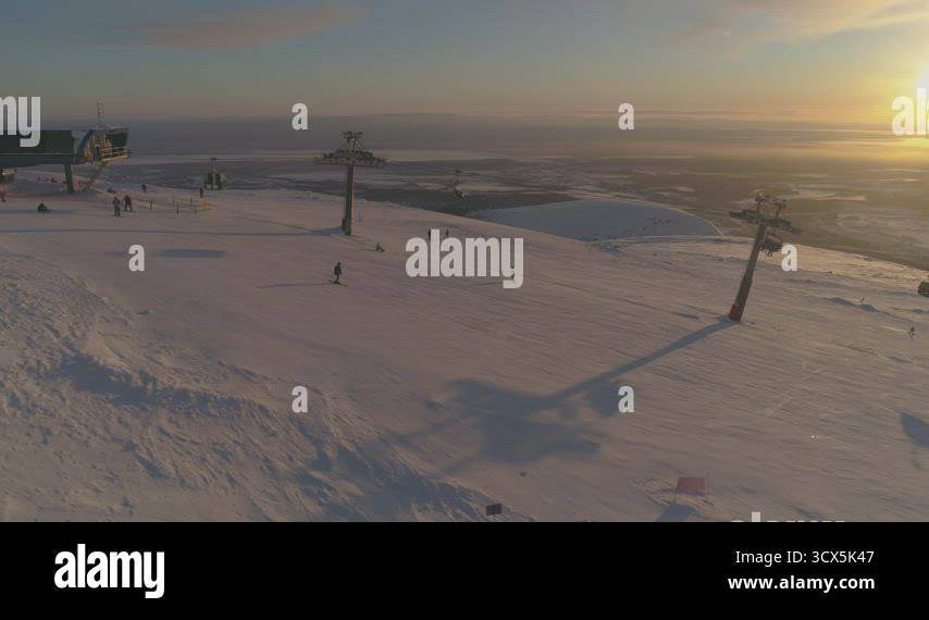 People are Skiing and Snowboarding on Ski Slope with Cable Car at Sunny ...