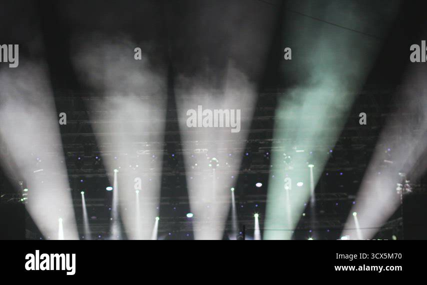 Flashing light beams from stage lights on a construction Stock Video ...