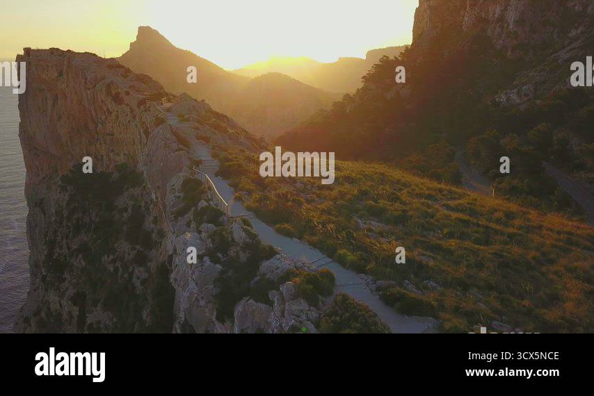 AERIAL WS Sunset over Cap de Formentor and Island of Illot el Colomer ...