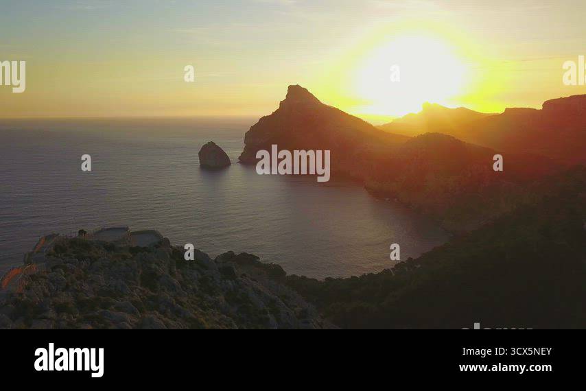 AERIAL WS Sunset over Cap de Formentor and Island of Illot el Colomer ...