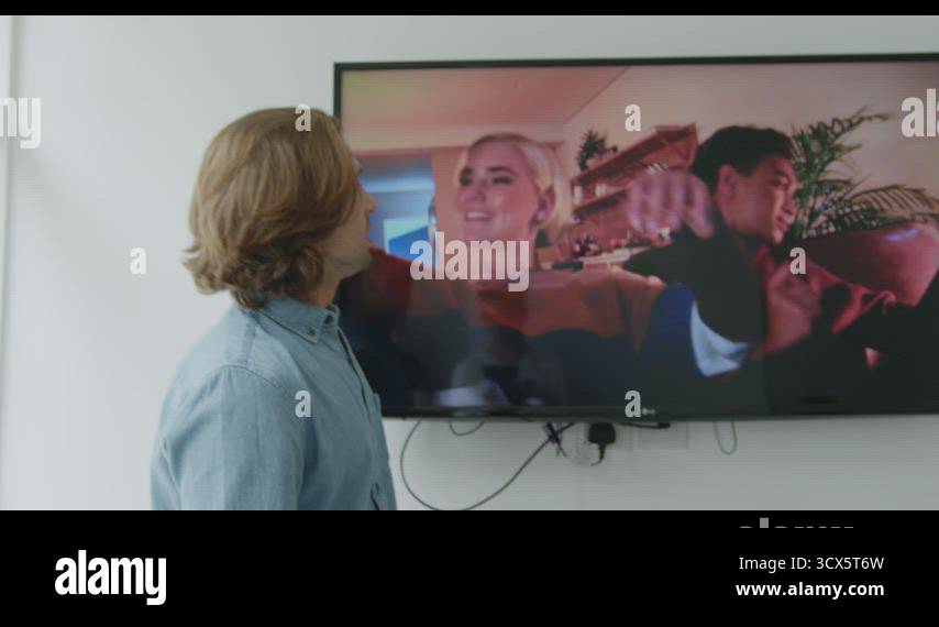 MS Man showing video during meeting in office, Soho, London, England ...
