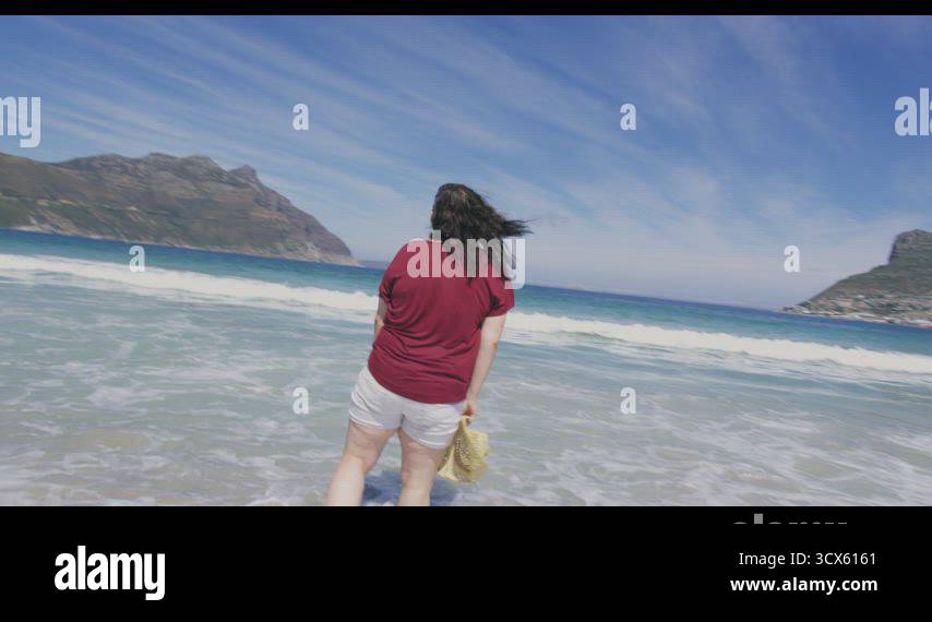 MS Two women wading in sea at sandy beach, Cape Town, South Africa ...