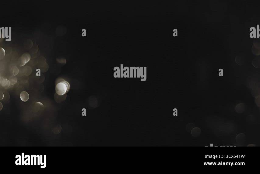 Black and white in motion defocused light glare on a black background ...