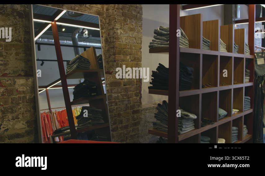 MS Woman wearing denim jacket against mirror in boutique at King's ...