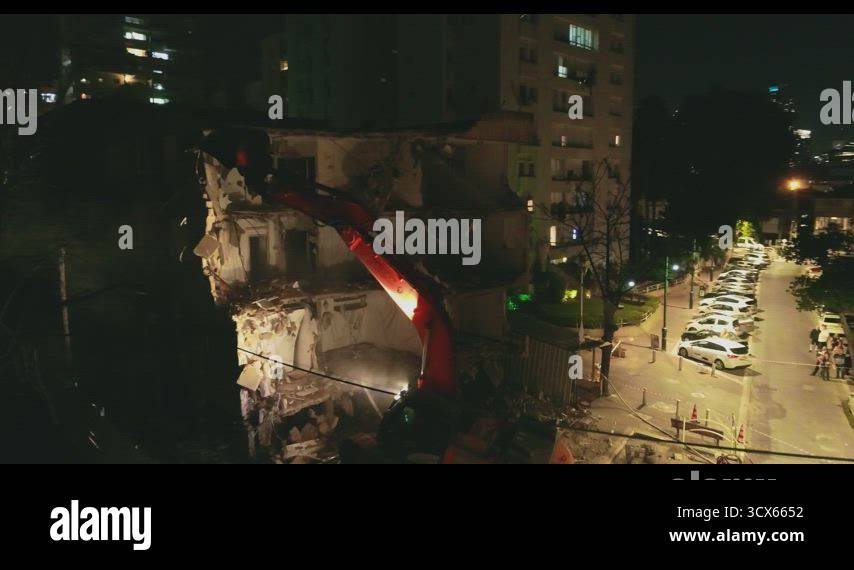 Excavator Destroying Concrete Wall. Aerial shot above. Excavator ...