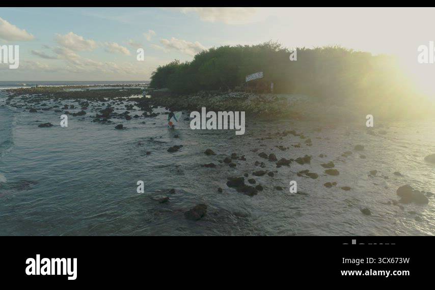 Top Down Aerial tracking shot on skilled male surfer riding a huge wave ...