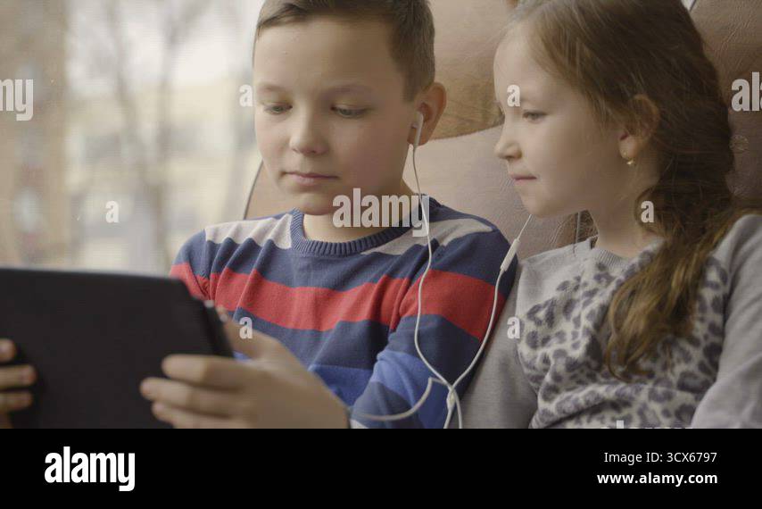 close-up shot of a young boy and girl traveling by bus through city ...