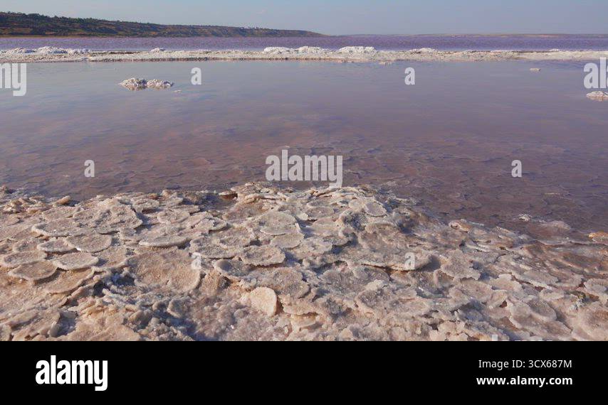 Salt lake, salt crystals. Salt water waves crash onto the shore in the ...