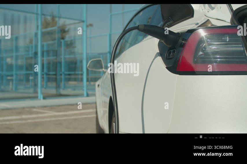 Female hand plugs off a charging cable from an electric car Stock Video ...