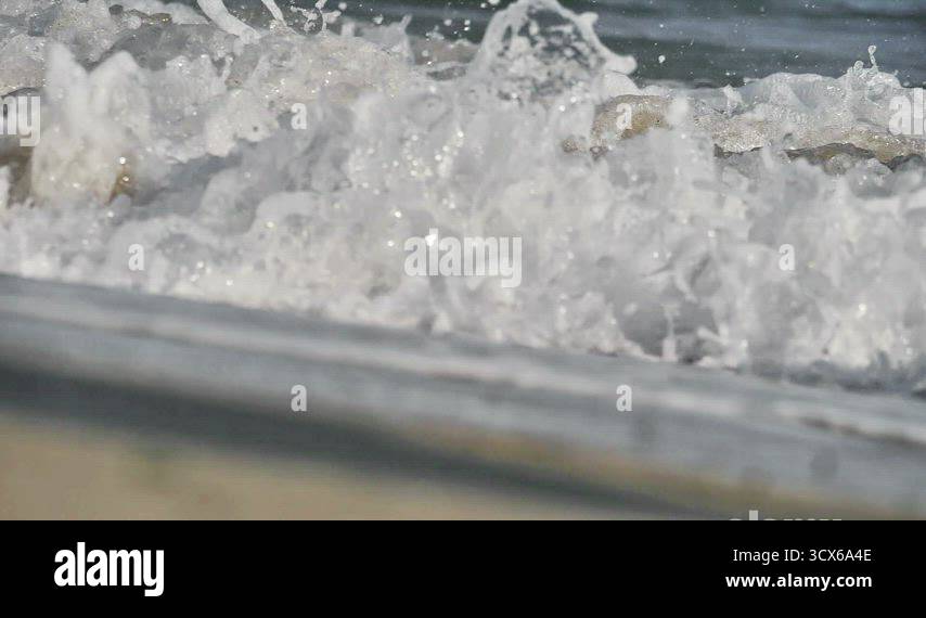 beach wave macro slow motion Stock Video Footage - Alamy
