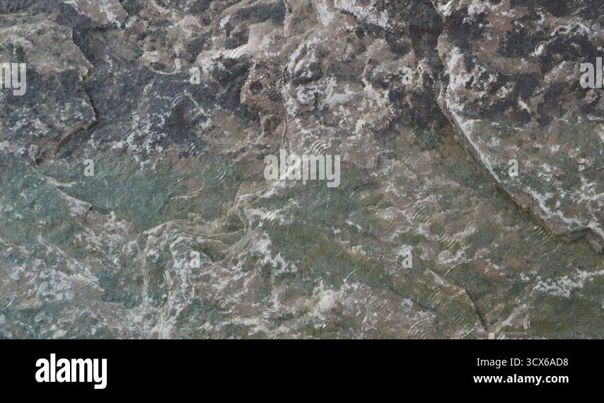rain drop on mineral and hard heavy granite stone surface of cave for ...