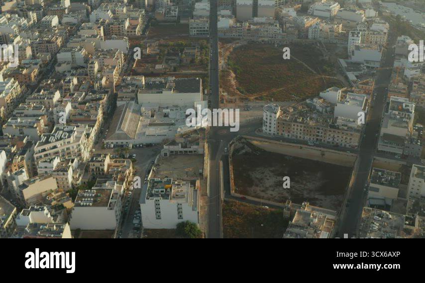 Road going through City on Malta Island with little car traffic and ...