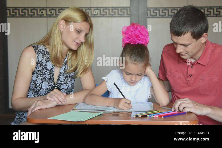 Schoolgirl doing homework with their parents smile looked into the ...