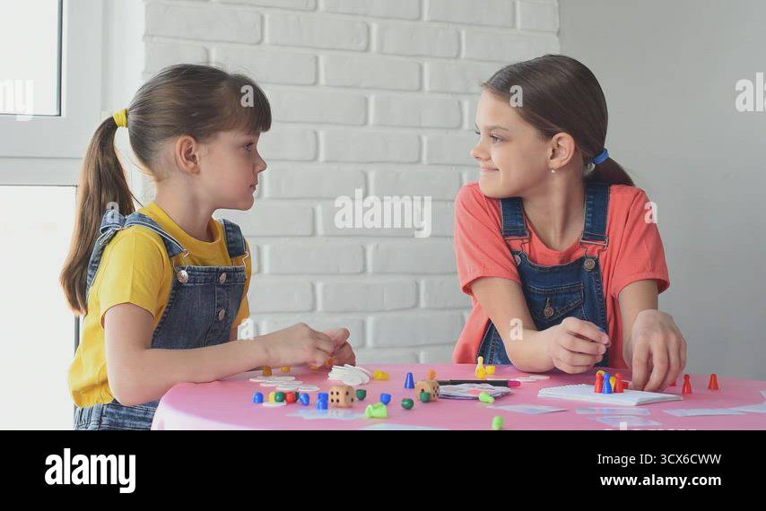 Two girls play board games and hug each other Stock Video Footage - Alamy