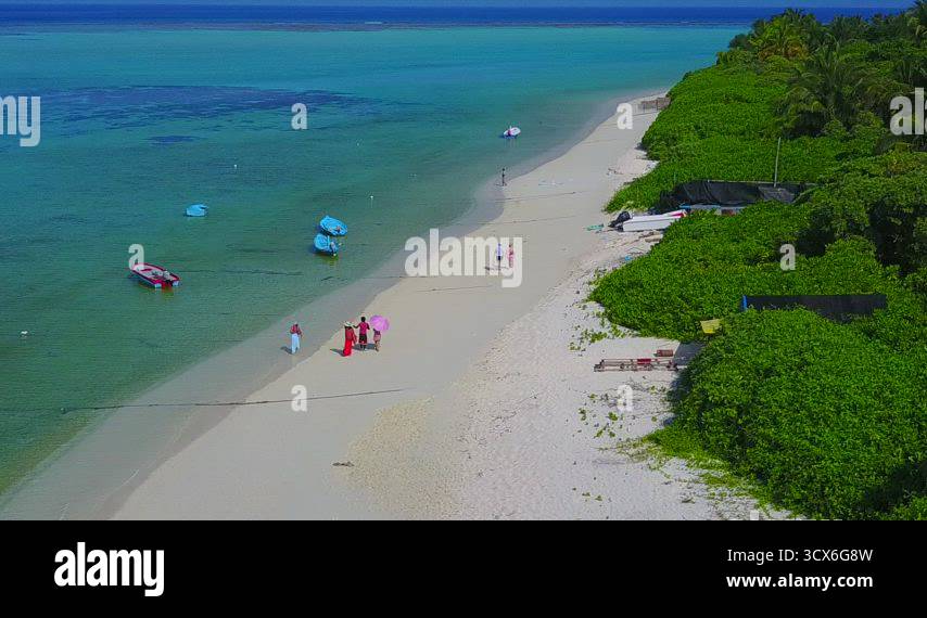 Aerial panorama of tranquil seashore beach voyage by clear water with ...