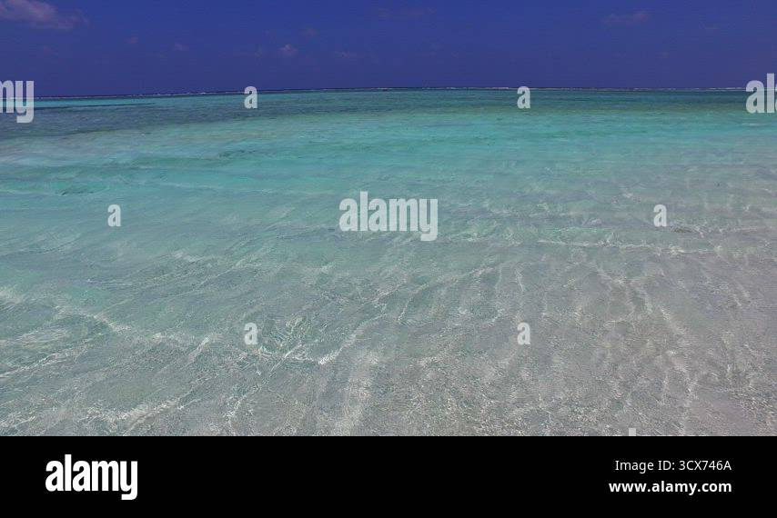 Sunny seascape of idyllic seashore beach journey by aqua blue lagoon ...