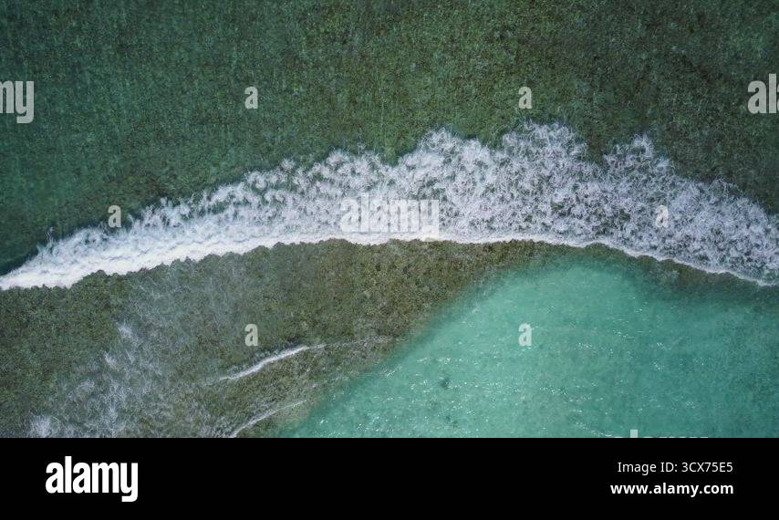 Empty scenery of tropical coast beach break by clear lagoon and bright ...